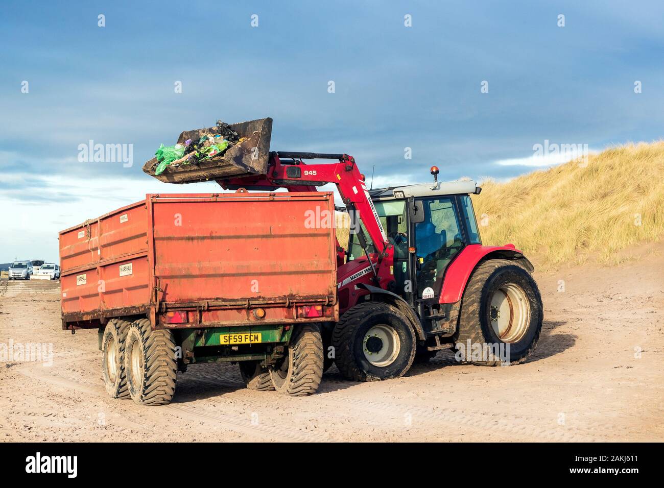 Tractor and trailer being used to clean the pollution and rubbish from ...