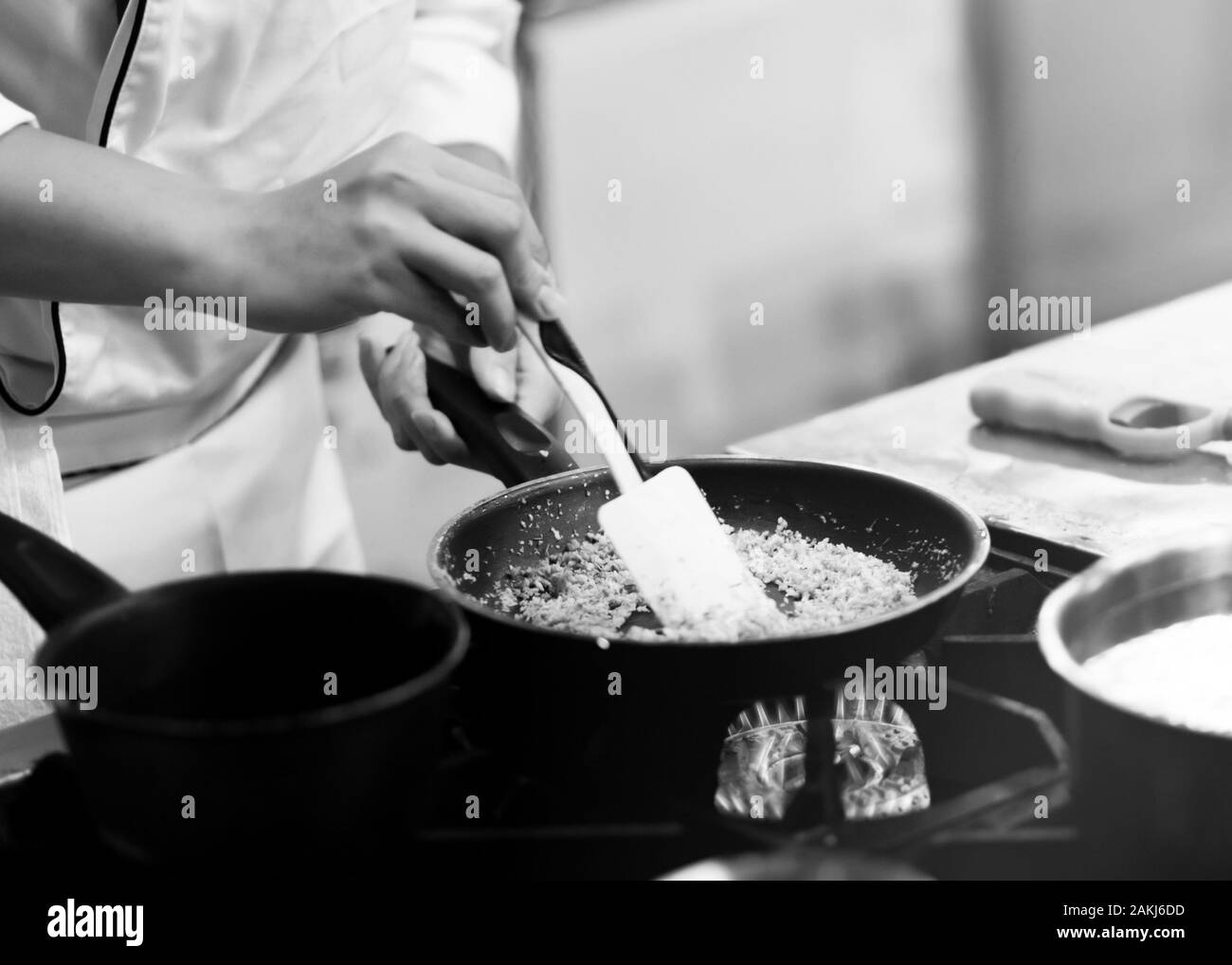 Chef cooking in a kitchen, chef at work, Black & White Stock Photo - Alamy