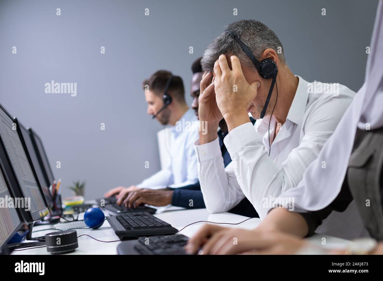 Mature Depressed Businessman Sitting At Office Desk Stock Photo - Alamy