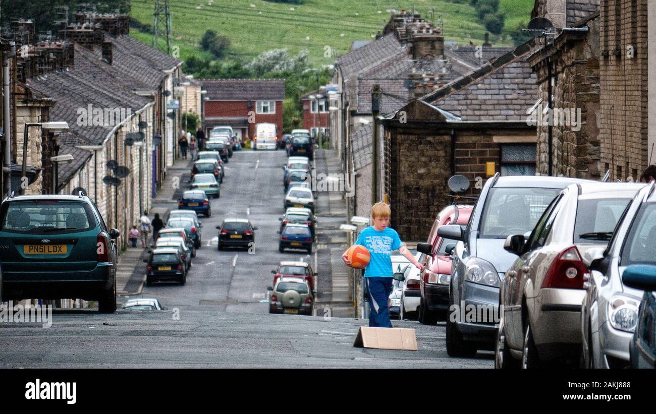 Kid playing in busy street at Rishton Stock Photo - Alamy