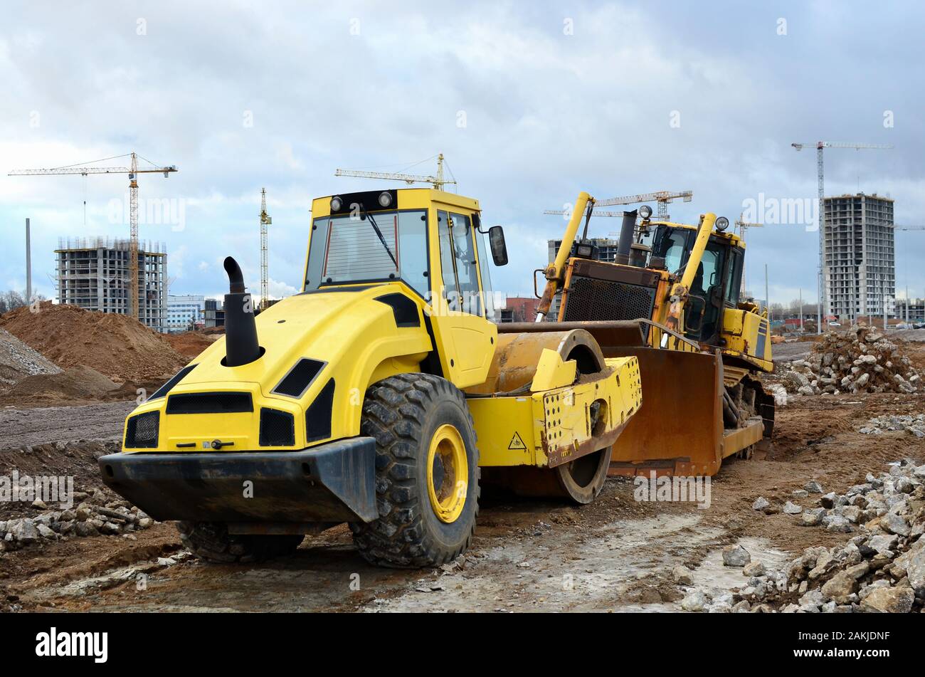 Soil Compactor and bulldozer at construction site. Vibration single ...