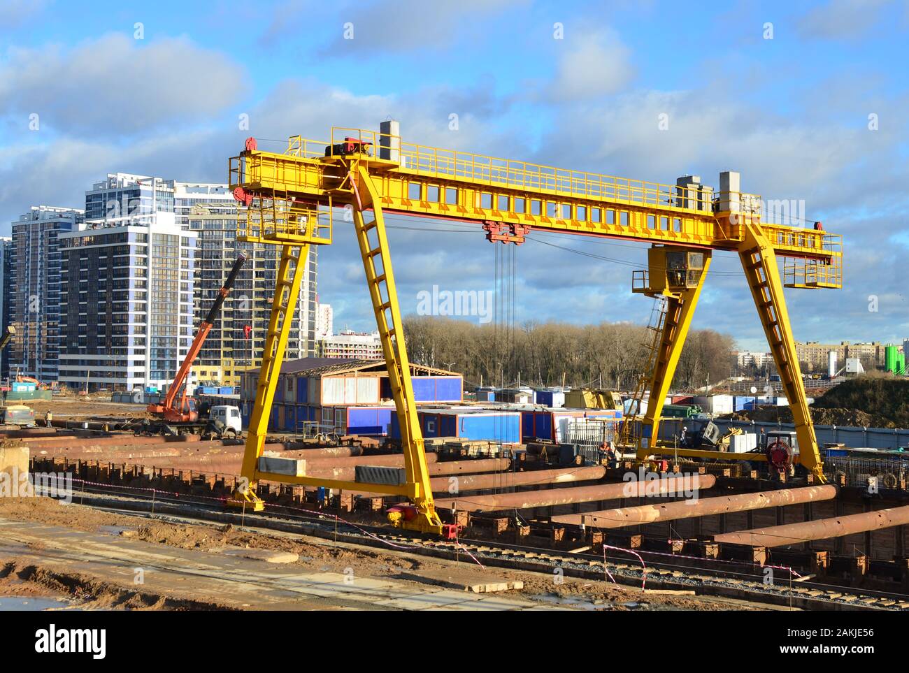 Gantry crane and auto crane working at construction site. Digging a pit ...