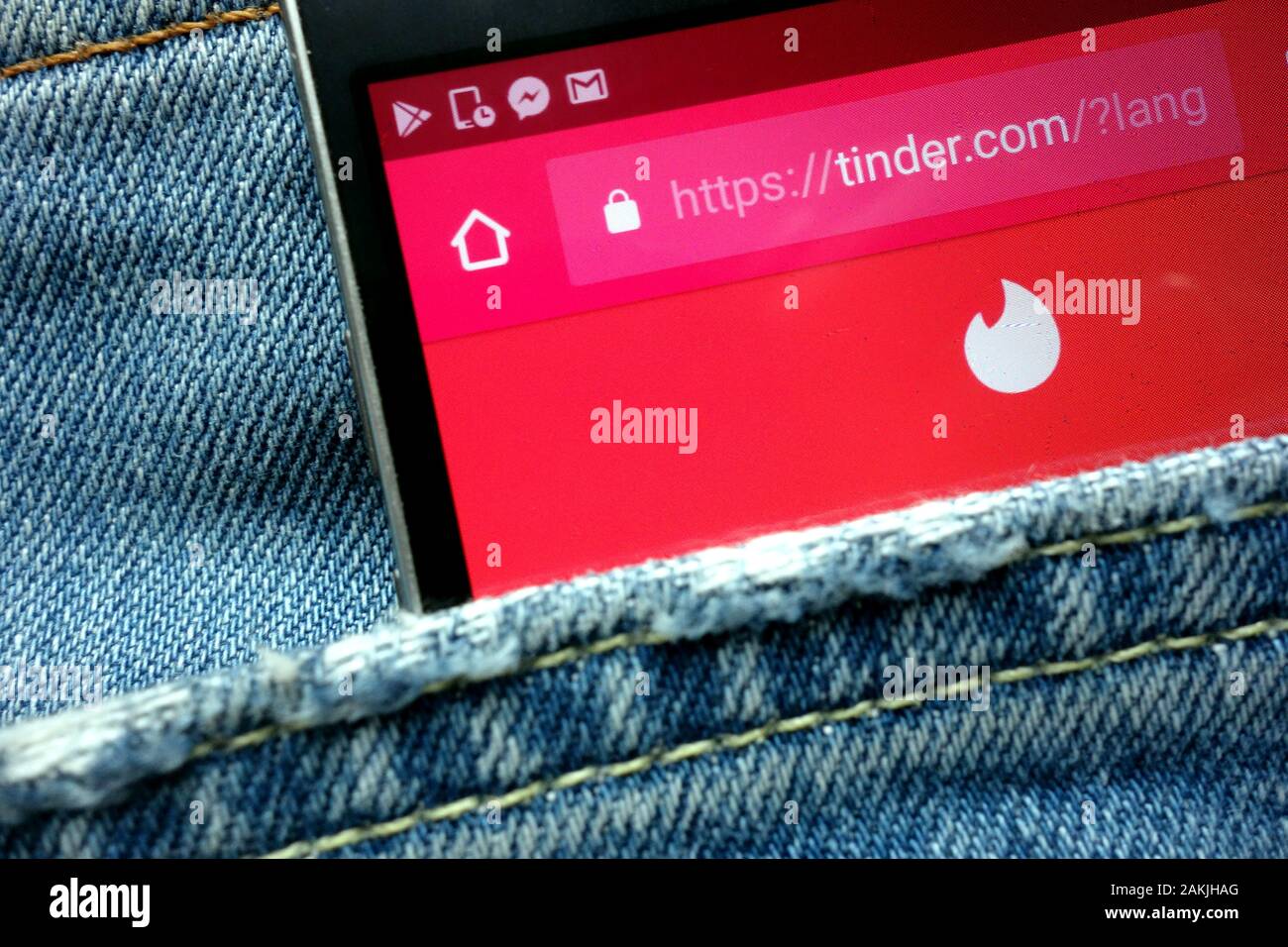 Tinder website displayed on smartphone hidden in jeans pocket Stock ...