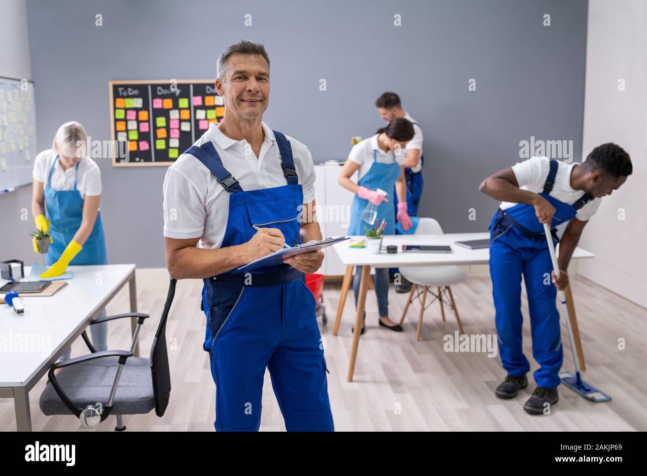 Janitor With His Team Cleaning Modern Office Stock Photo - Alamy