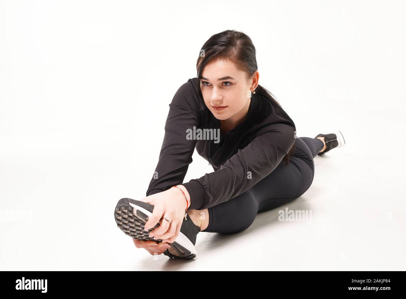 Young athletic woman making yoga and gymnastics stretching exercises ...