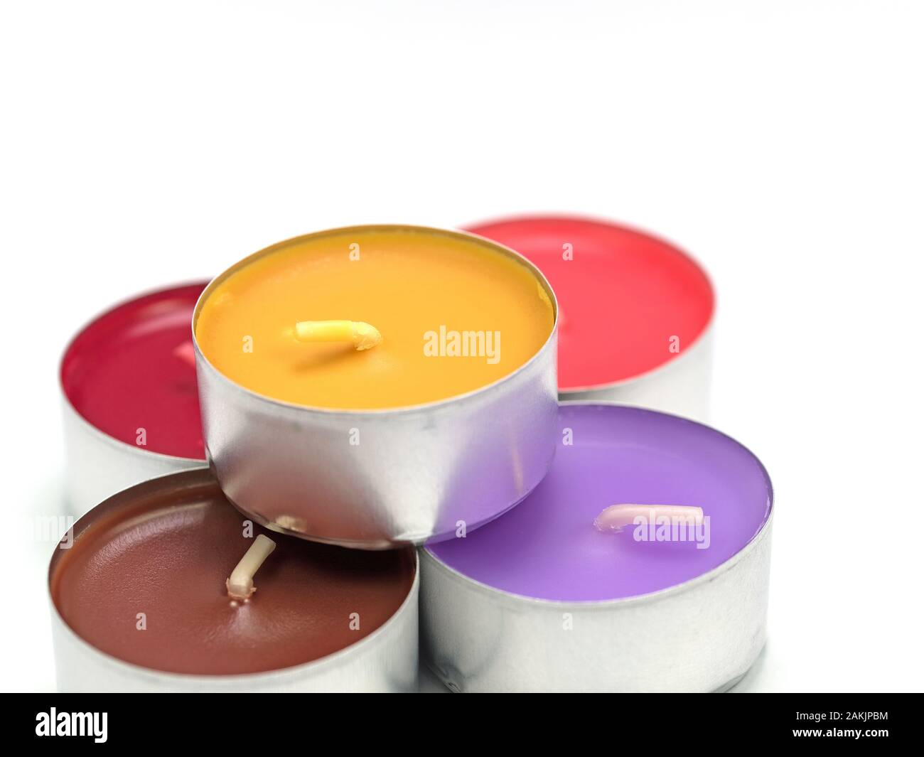 Colorful tea lights against white background Stock Photo - Alamy