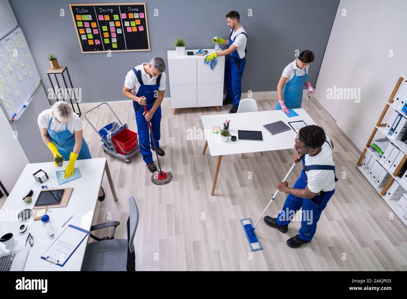Group Of Janitors In Uniform Cleaning The Office With Cleaning ...