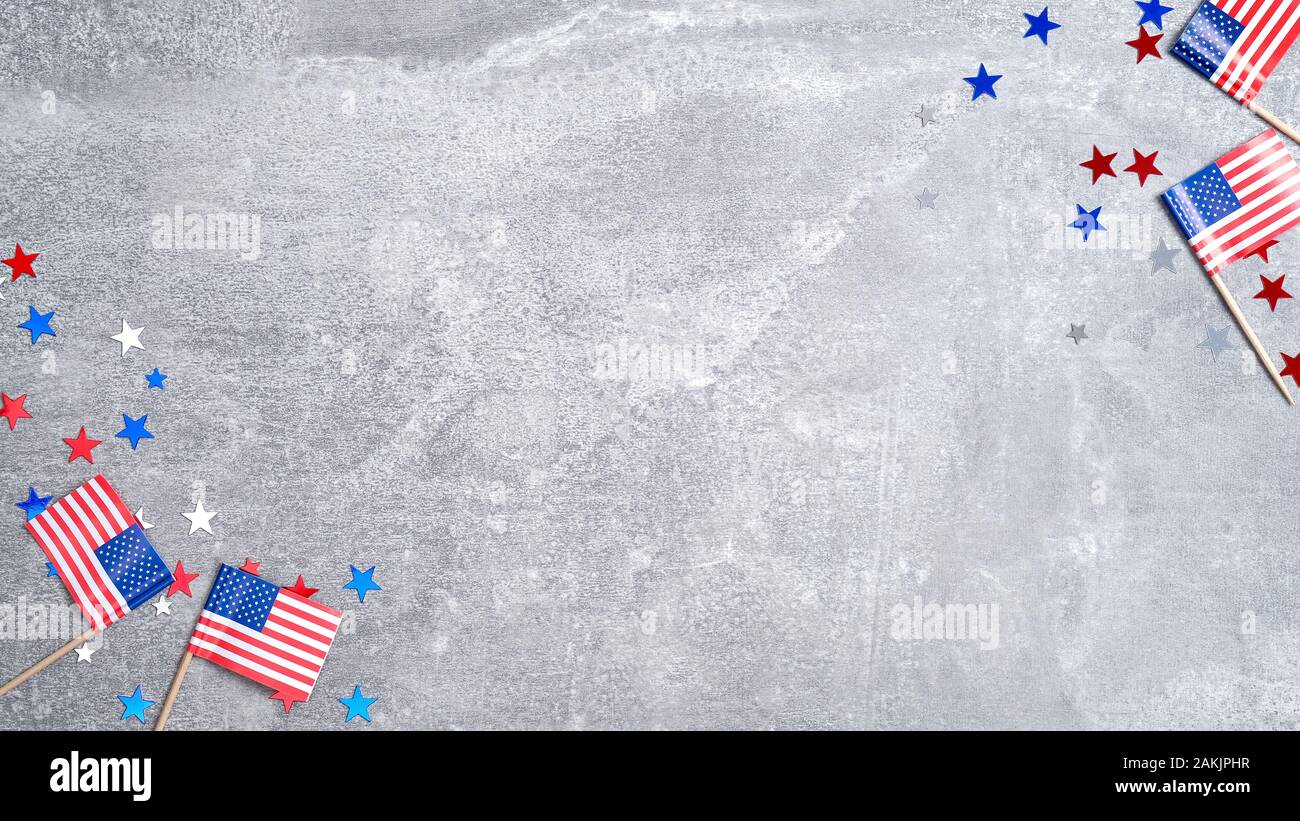 Frame made of American flags and confetti stars on concrete stone ...