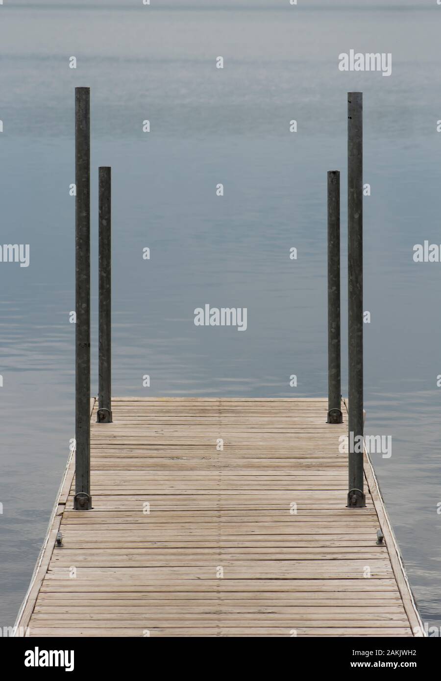 Wooden dock and blue water Stock Photo - Alamy