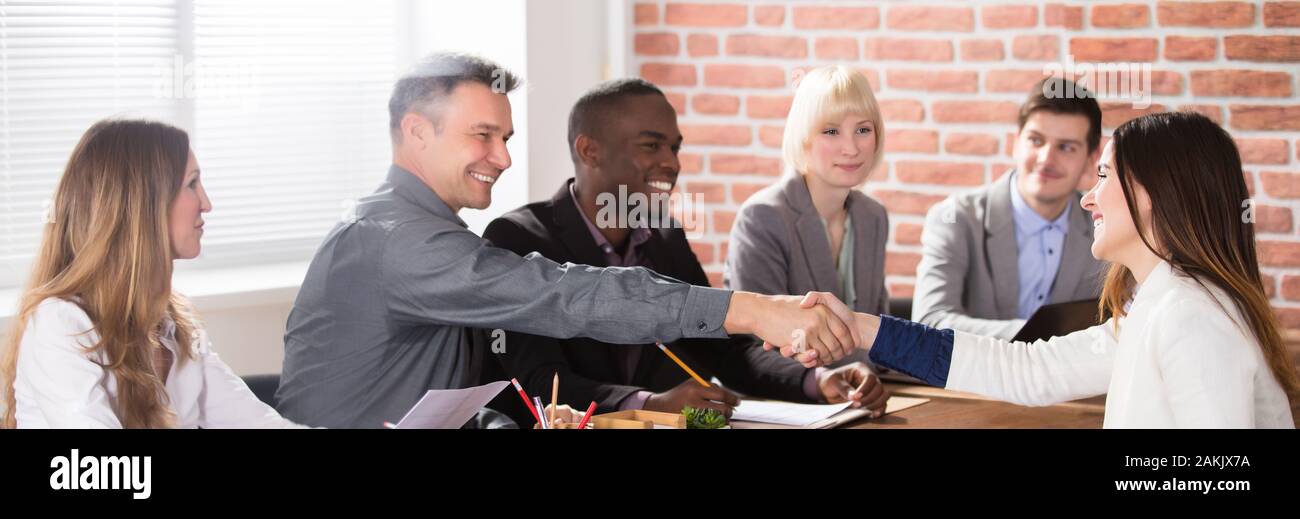 Businesspeople Shaking Hands After Interview In Office Stock Photo - Alamy
