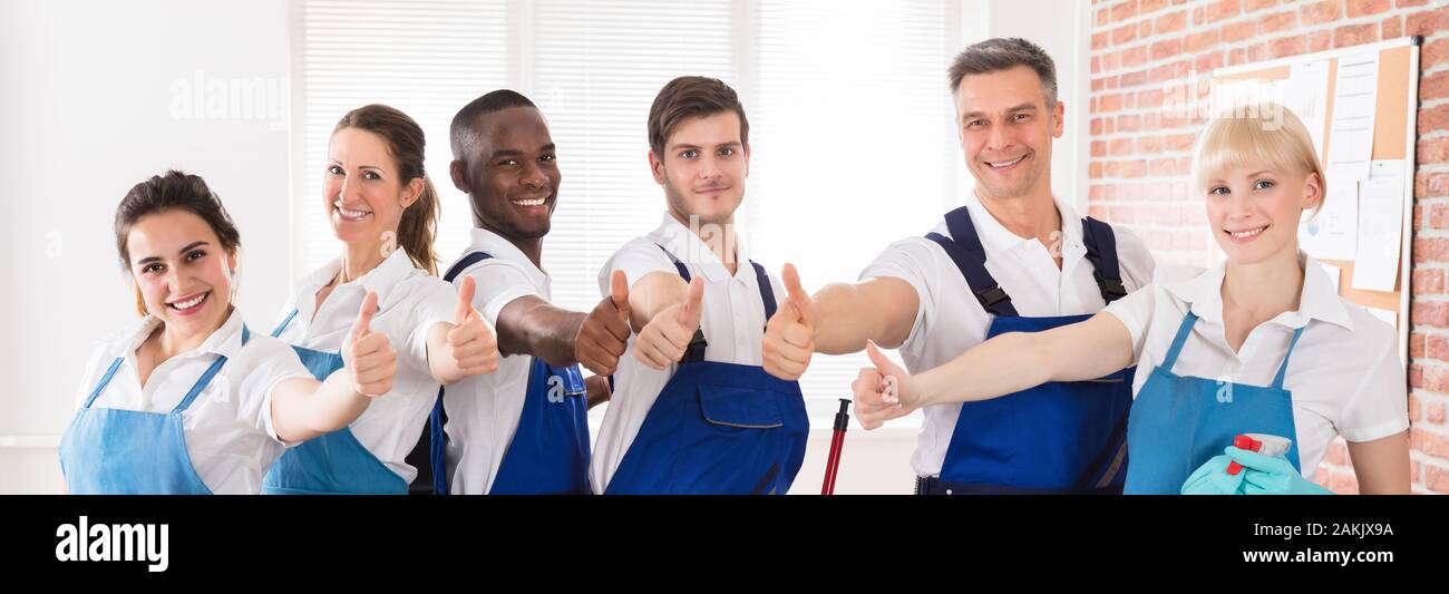 Happy Diverse Cleaners In The Office Showing Thumb Up Sign Stock Photo ...