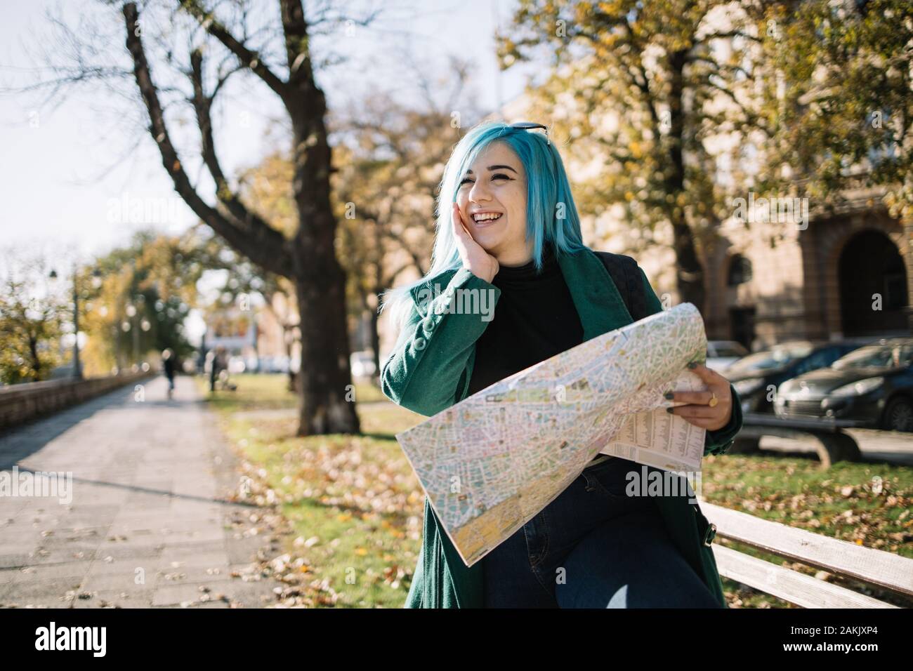 Lost tourist searching direction in a map Stock Photo - Alamy