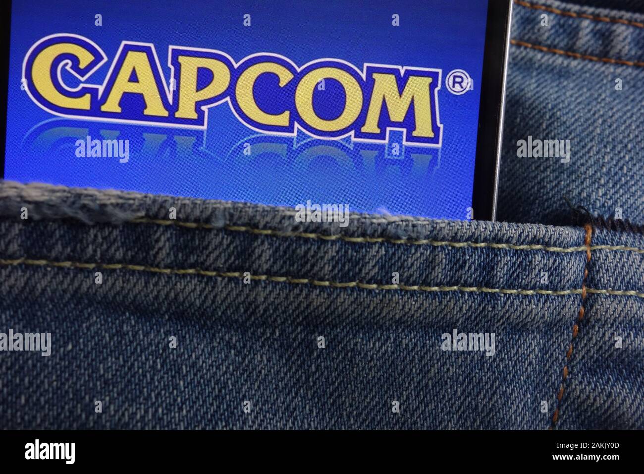 Capcom logo displayed on smartphone hidden in jeans pocket Stock Photo ...