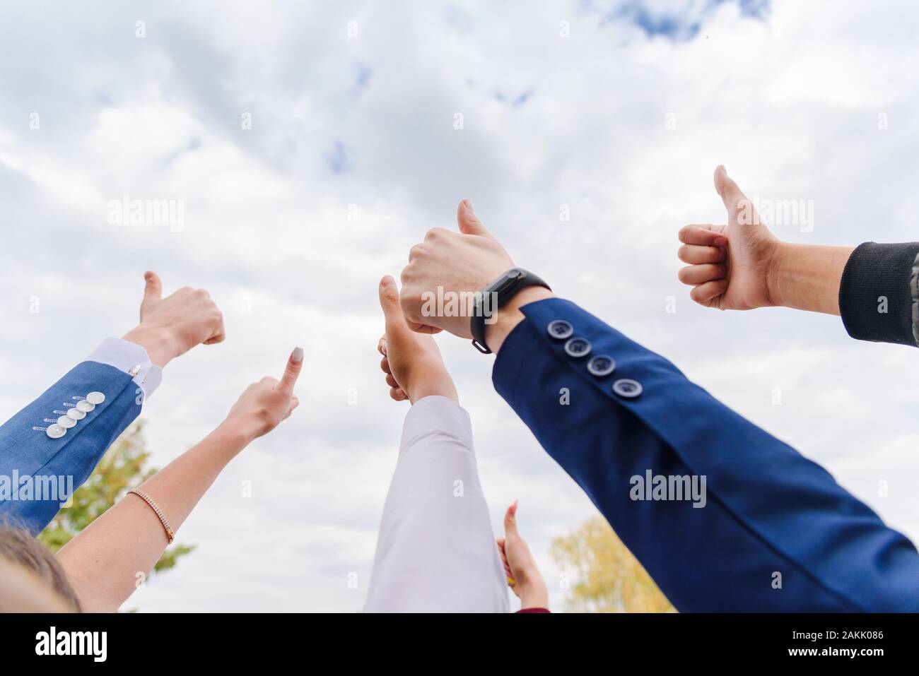 Teamwork concept, many people hold thumbs up. Vote for yes and ...