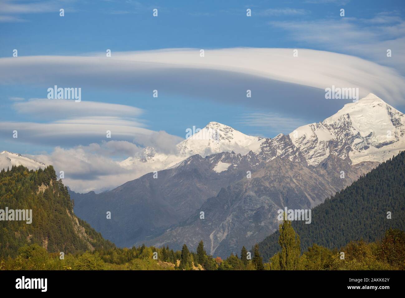 Lenticular clouds over the mountain peaks of the Caucasus Stock Photo ...