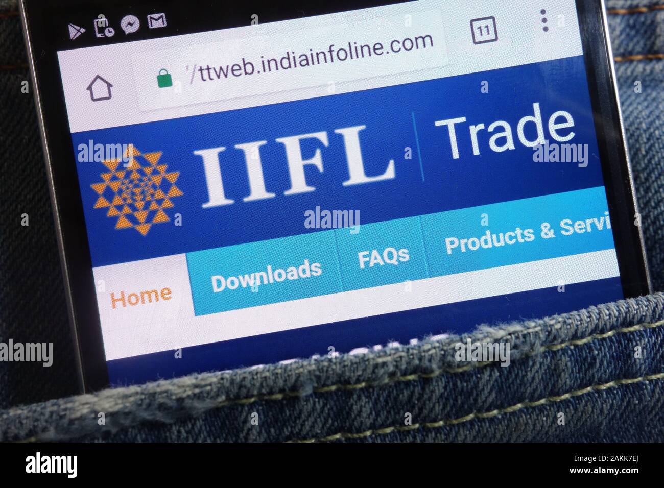 India Infoline Group website displayed on smartphone hidden in jeans ...