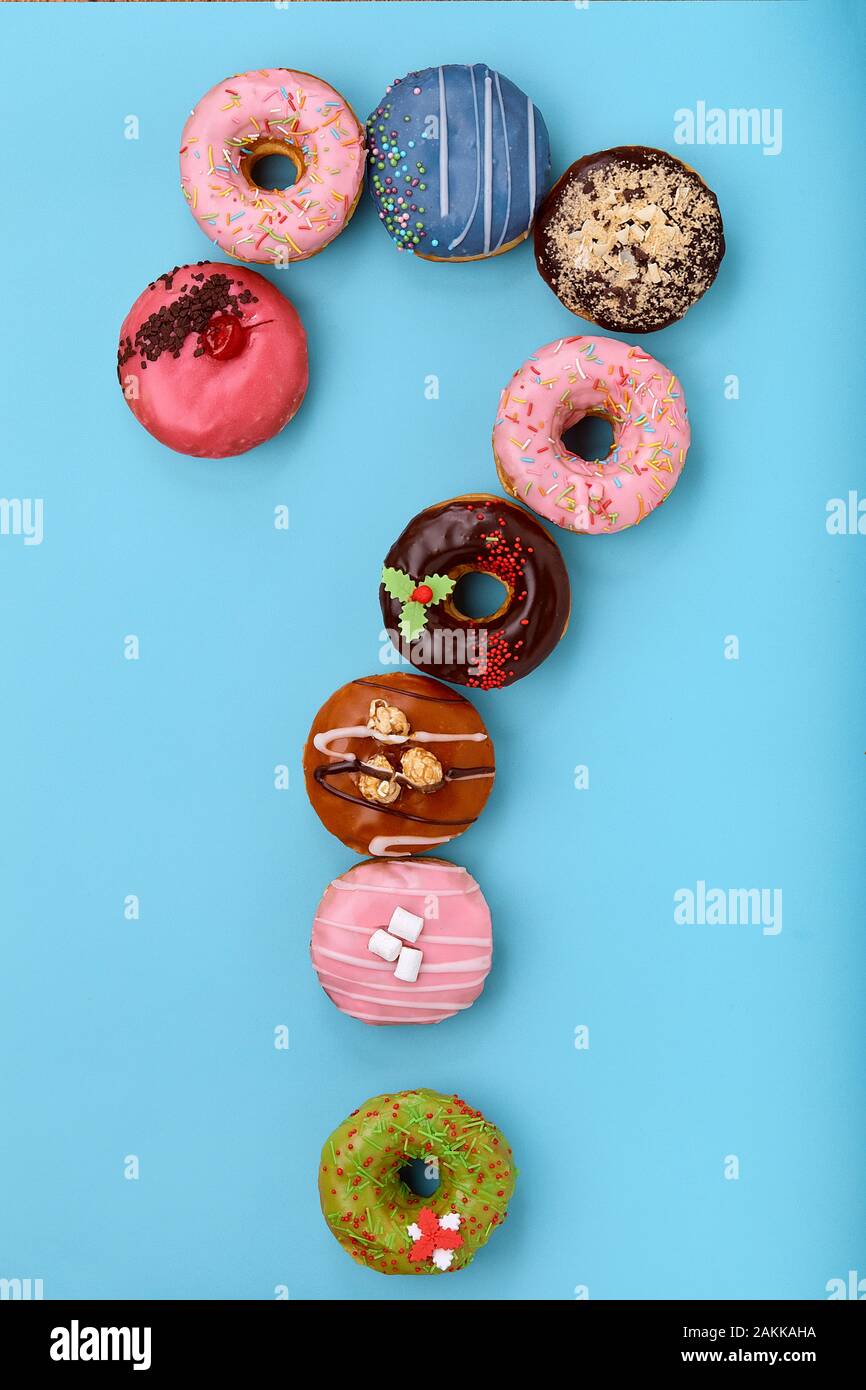 Question mark made of glazed colorful donuts on a blue background Stock ...