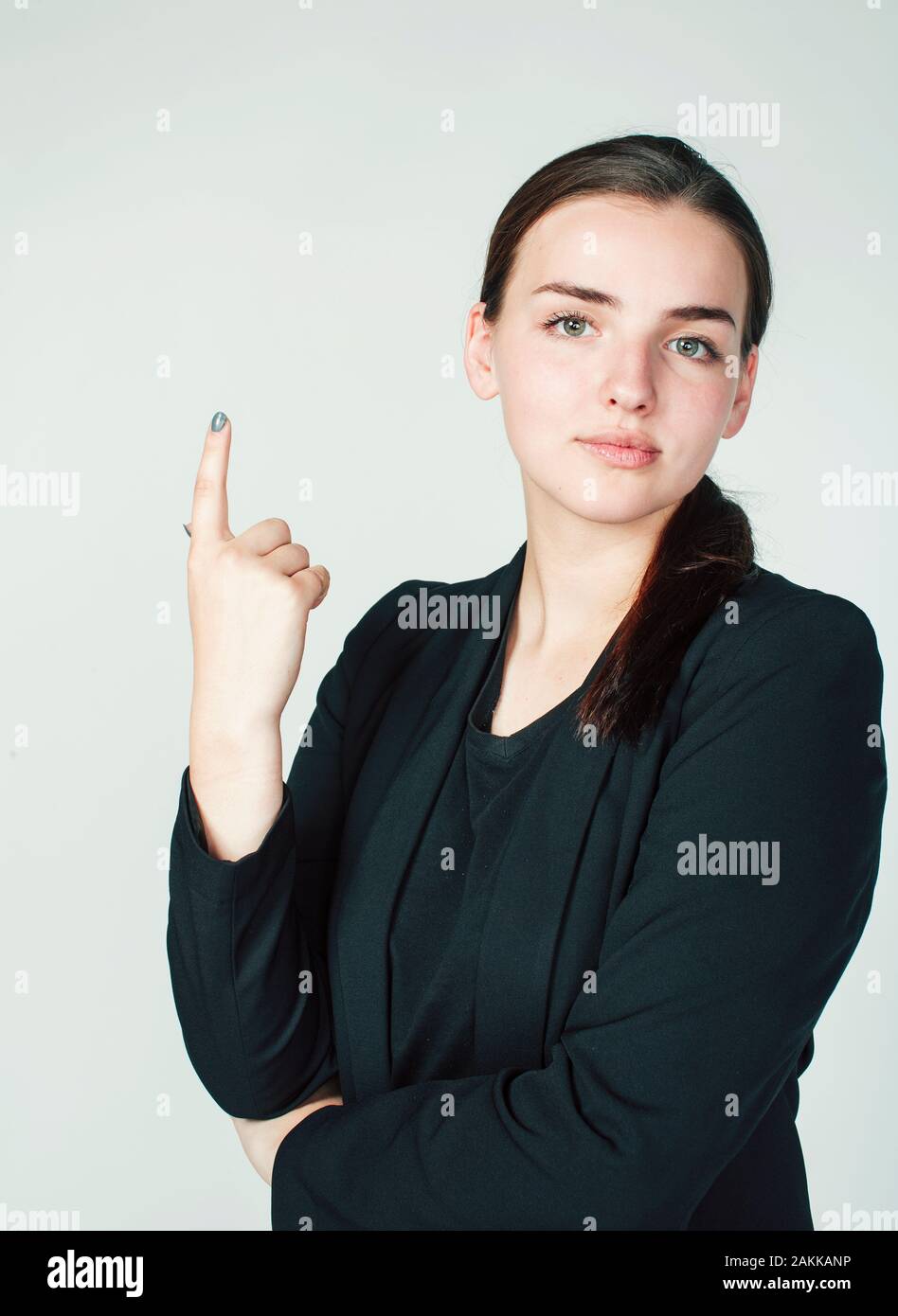 young pretty girl pointing and gesturing on white background, business ...