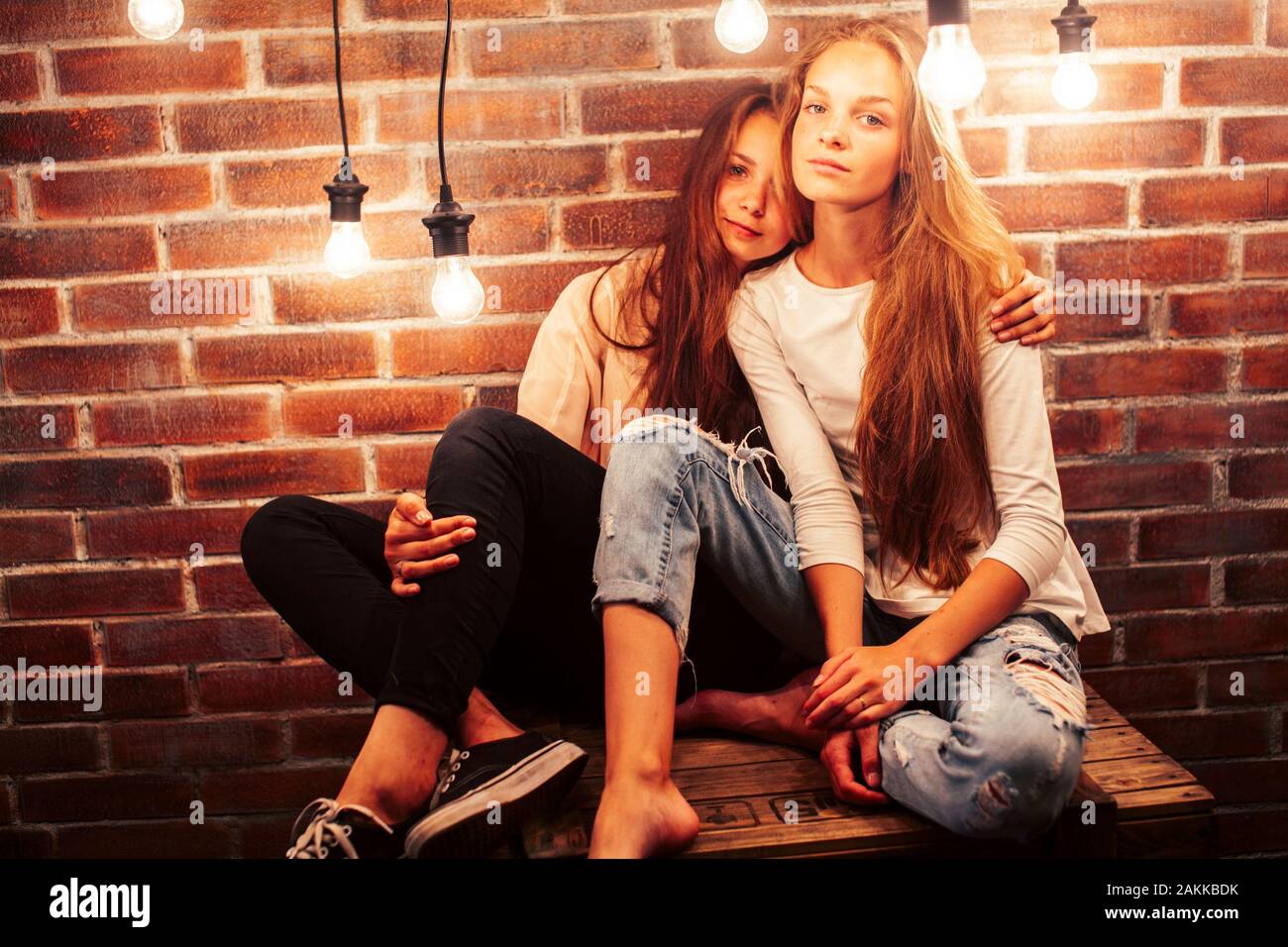 two teenage girl friends together having fun in modern loft interior ...