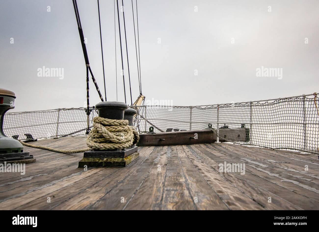 Old sail ship with wooden deck and its equipment; ropes, anchor ...