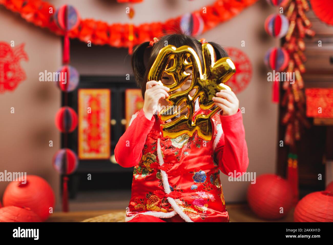 Chinese toddler girl traditional dressing up hold a Fu means 'lucky ...