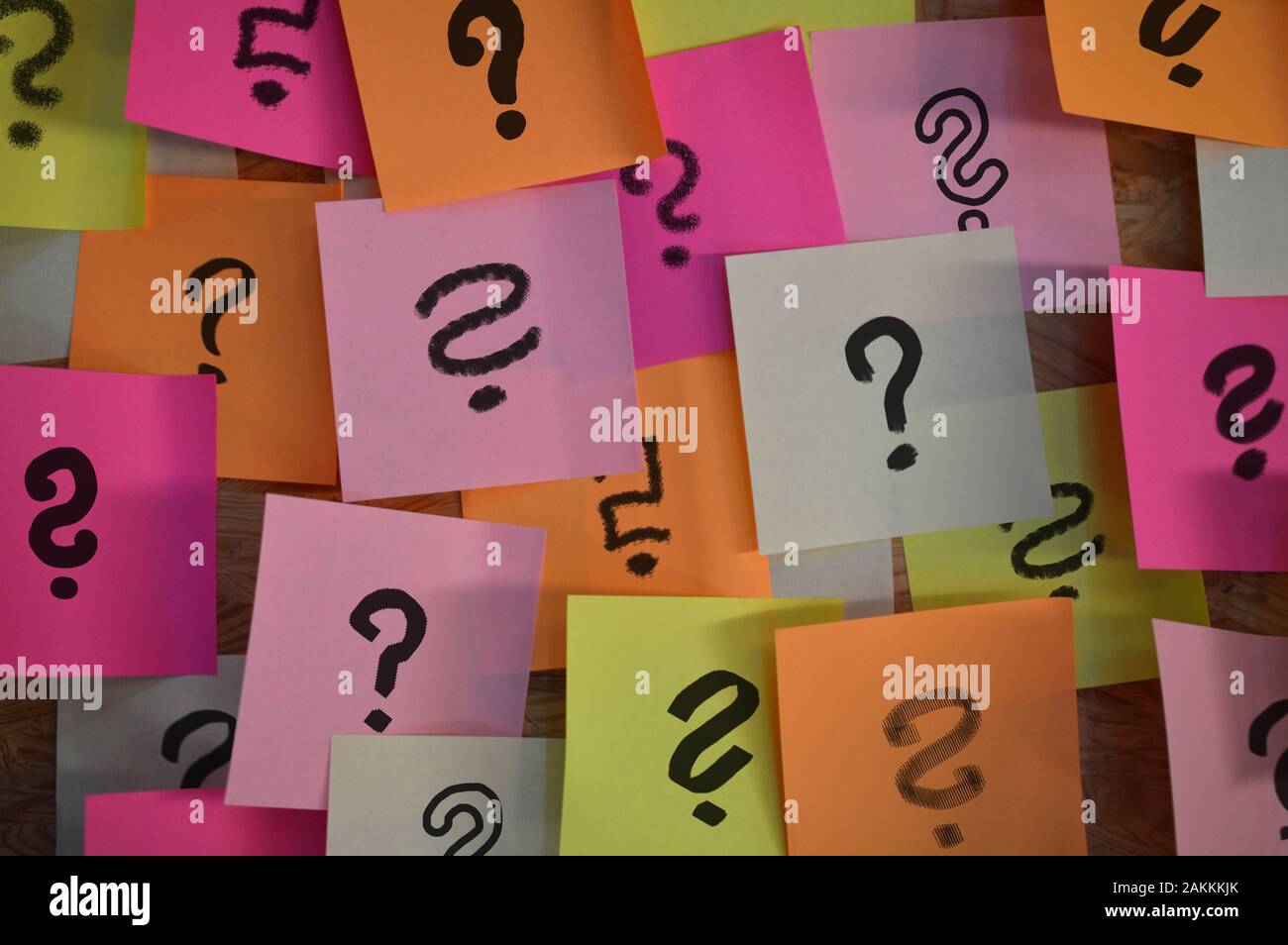 Handwritten different question marks on red, pink, white, yellow and ...