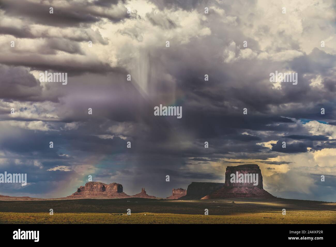 Dramatic clouds, rain and a rainbow over Monument Valley Stock Photo ...