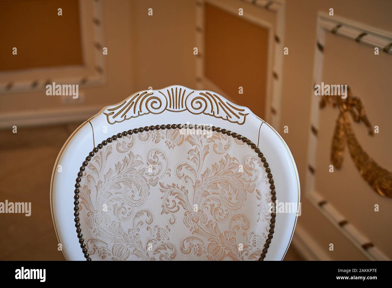 The back of an old classic chair, decorated with patterns of gold ...