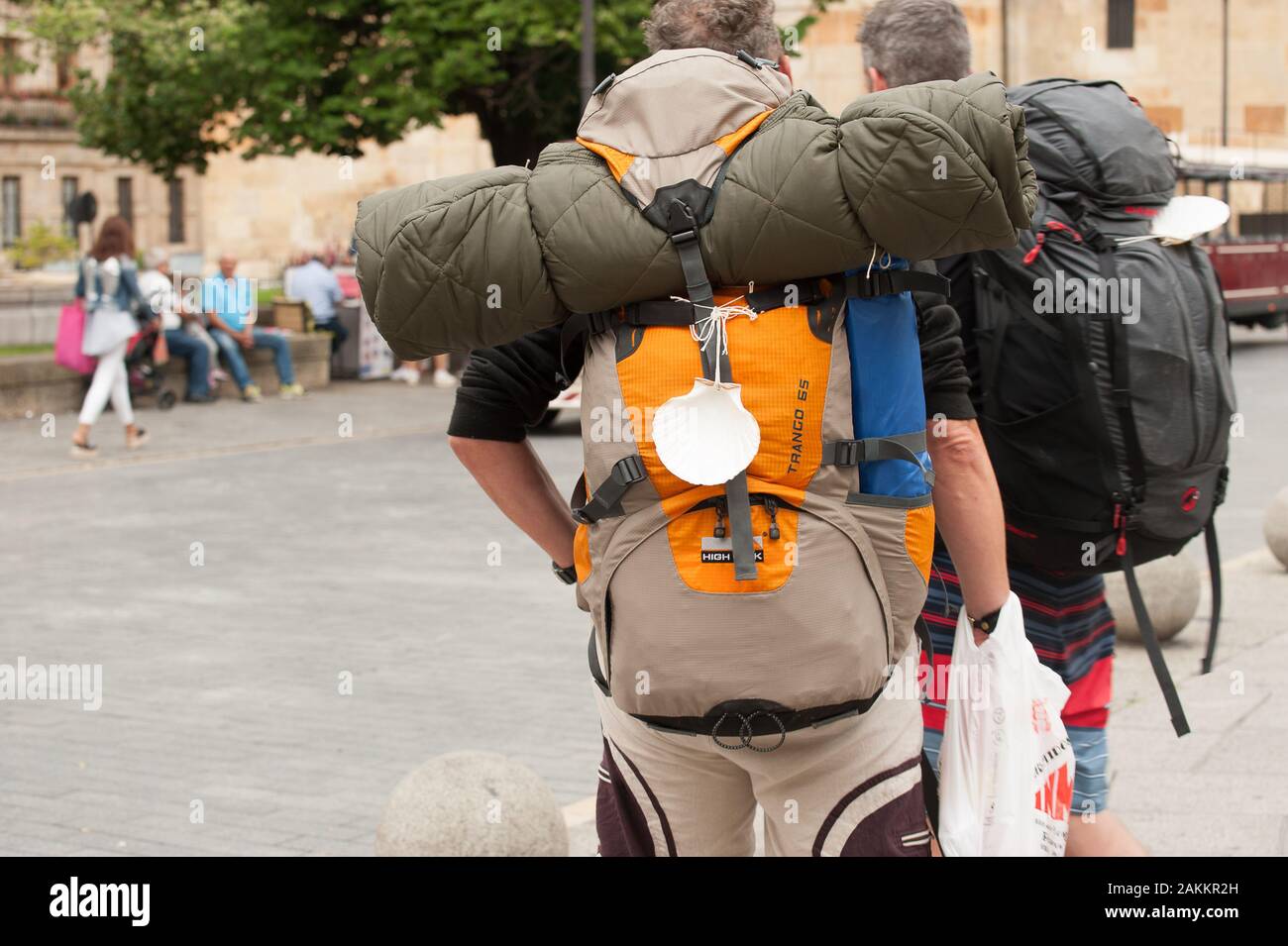 Pilgrims with a symbol of Santiago de Compostela - a shell Stock Photo ...