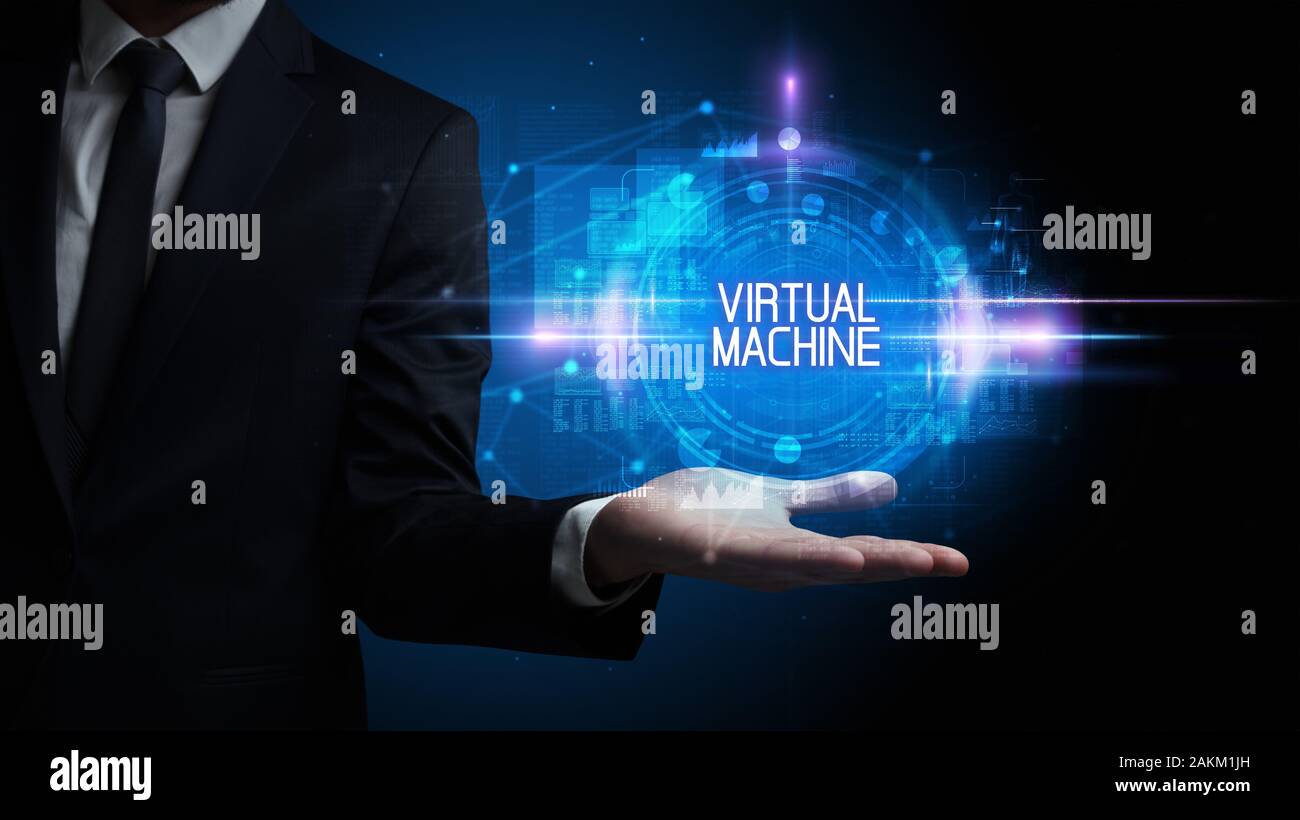 Man hand holding VIRTUAL MACHINE inscription, technology concept Stock ...