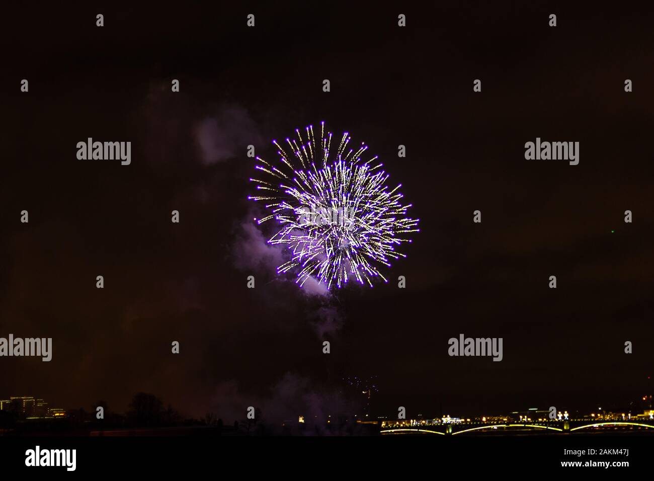 fireworks over the city moon and purple lights Stock Photo - Alamy