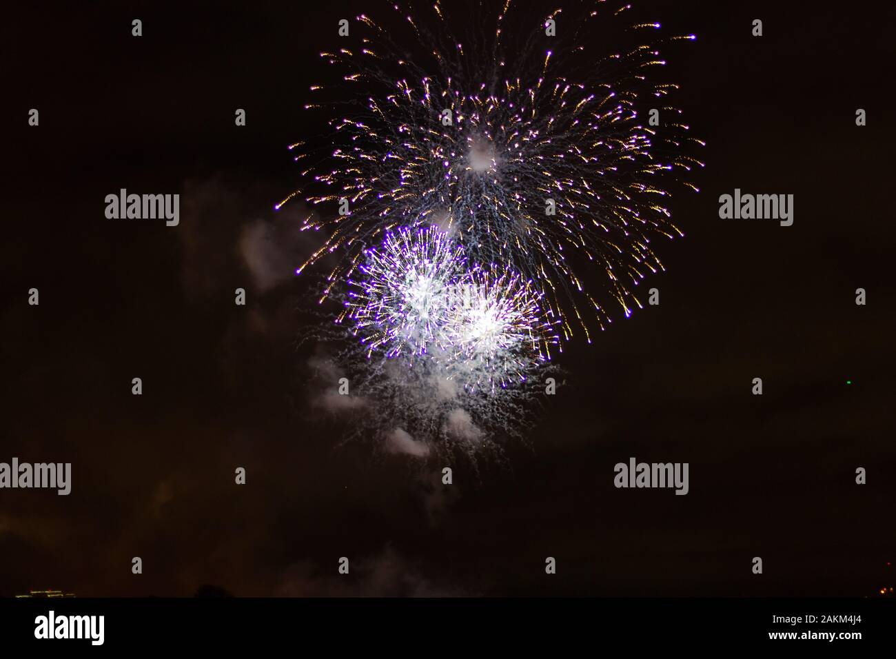 fireworks over the city moon and purple lights Stock Photo - Alamy