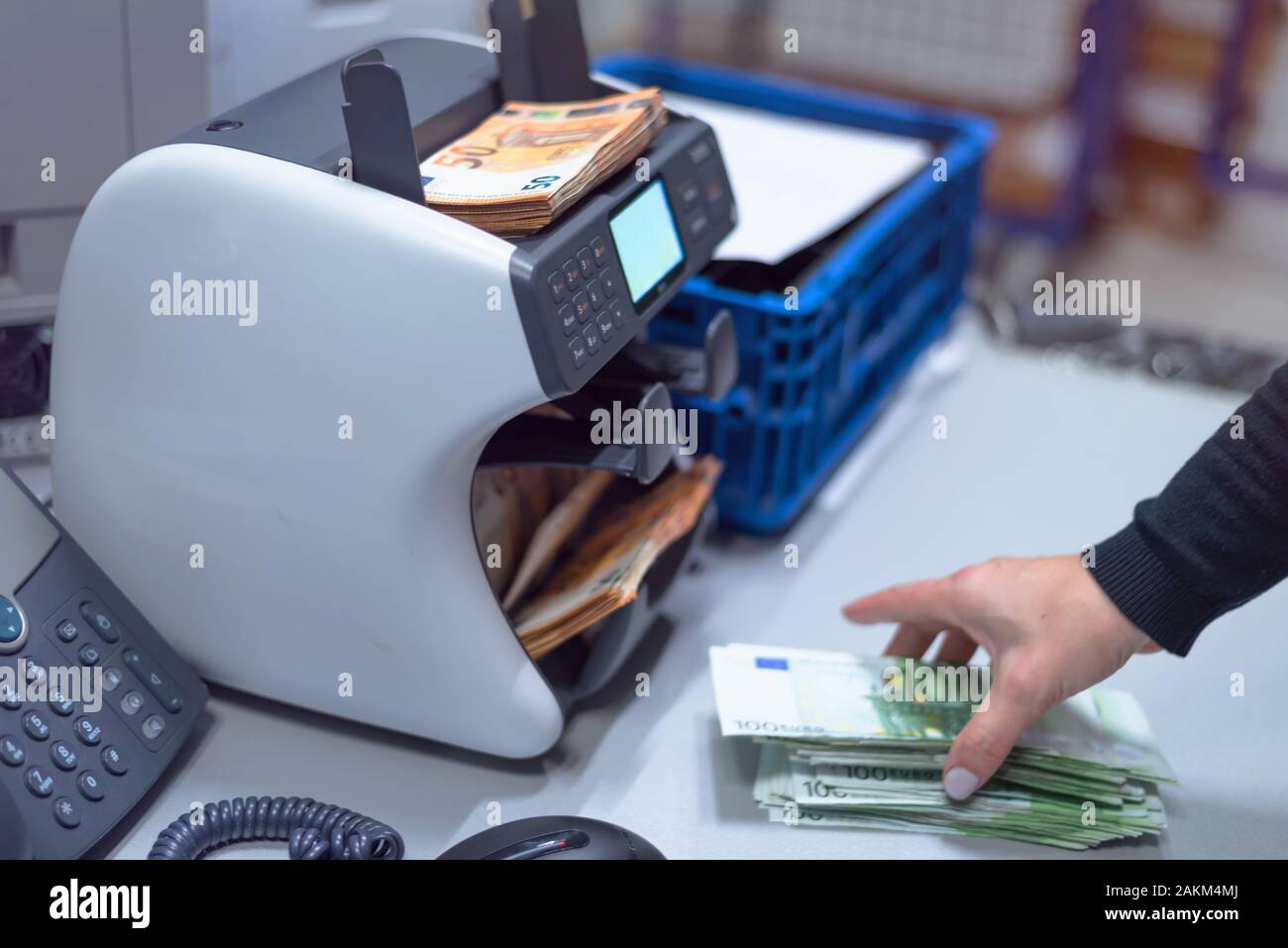 Bank employees sorting and counting money inside bank vault. Large ...