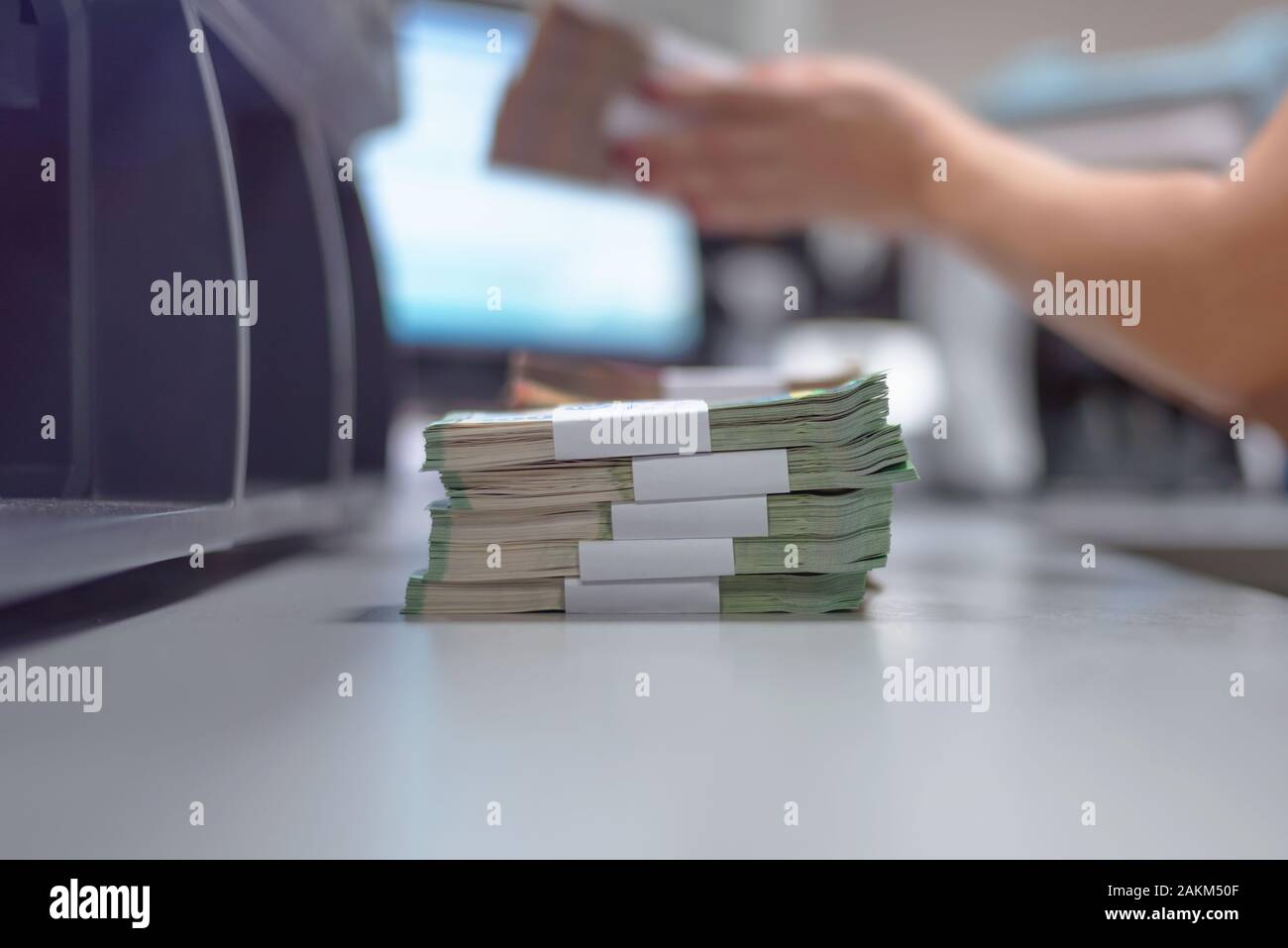 Bank employees sorting and counting money inside bank vault. Large ...