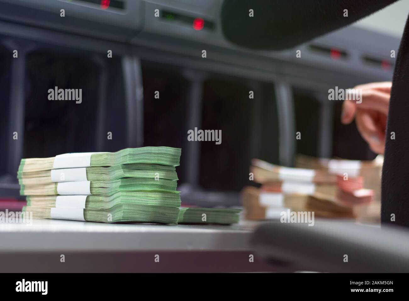 Bank employees sorting and counting money inside bank vault. Large ...
