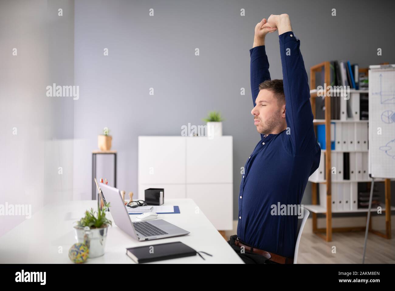 Man stretching in office hi-res stock photography and images - Alamy
