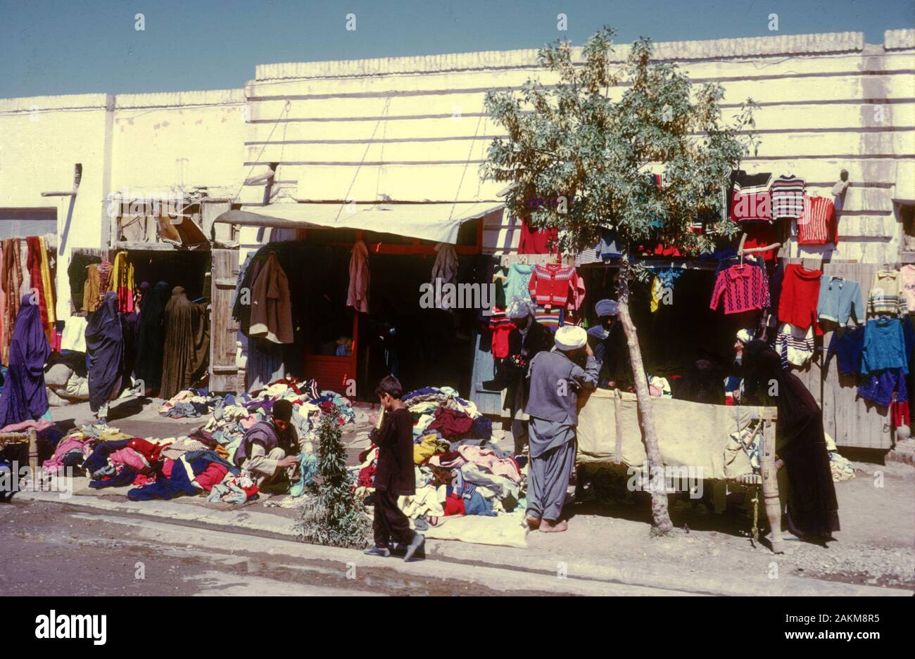 Afghan men and women shop for used clothing in Herat, Afghanistan, in ...