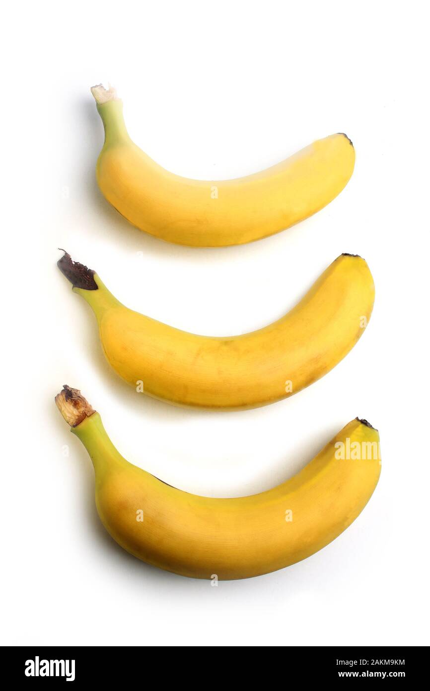 three bananas in a row isolated on white background flat lay Stock ...