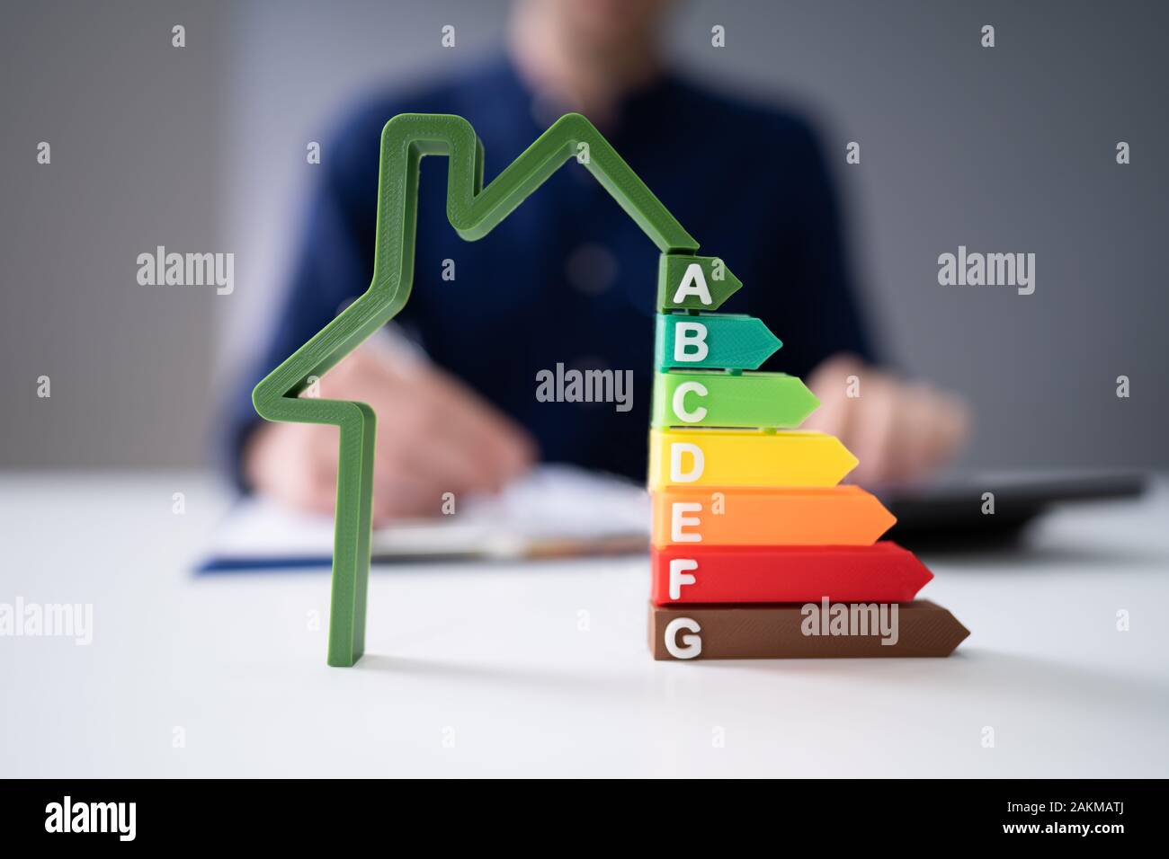 Midsection Of Businessman Calculating Invoice With Energy Efficient ...