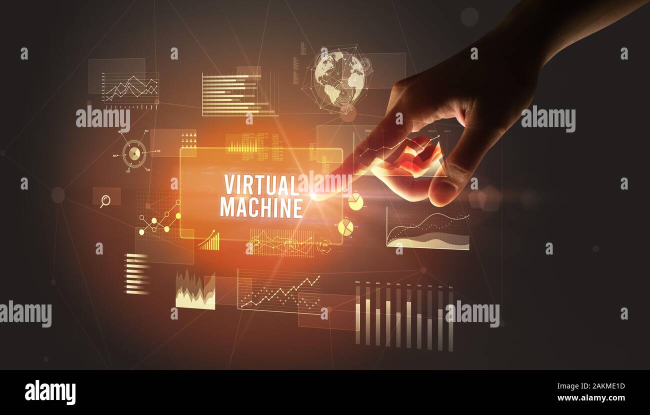 Hand touching VIRTUAL MACHINE inscription, new business technology ...