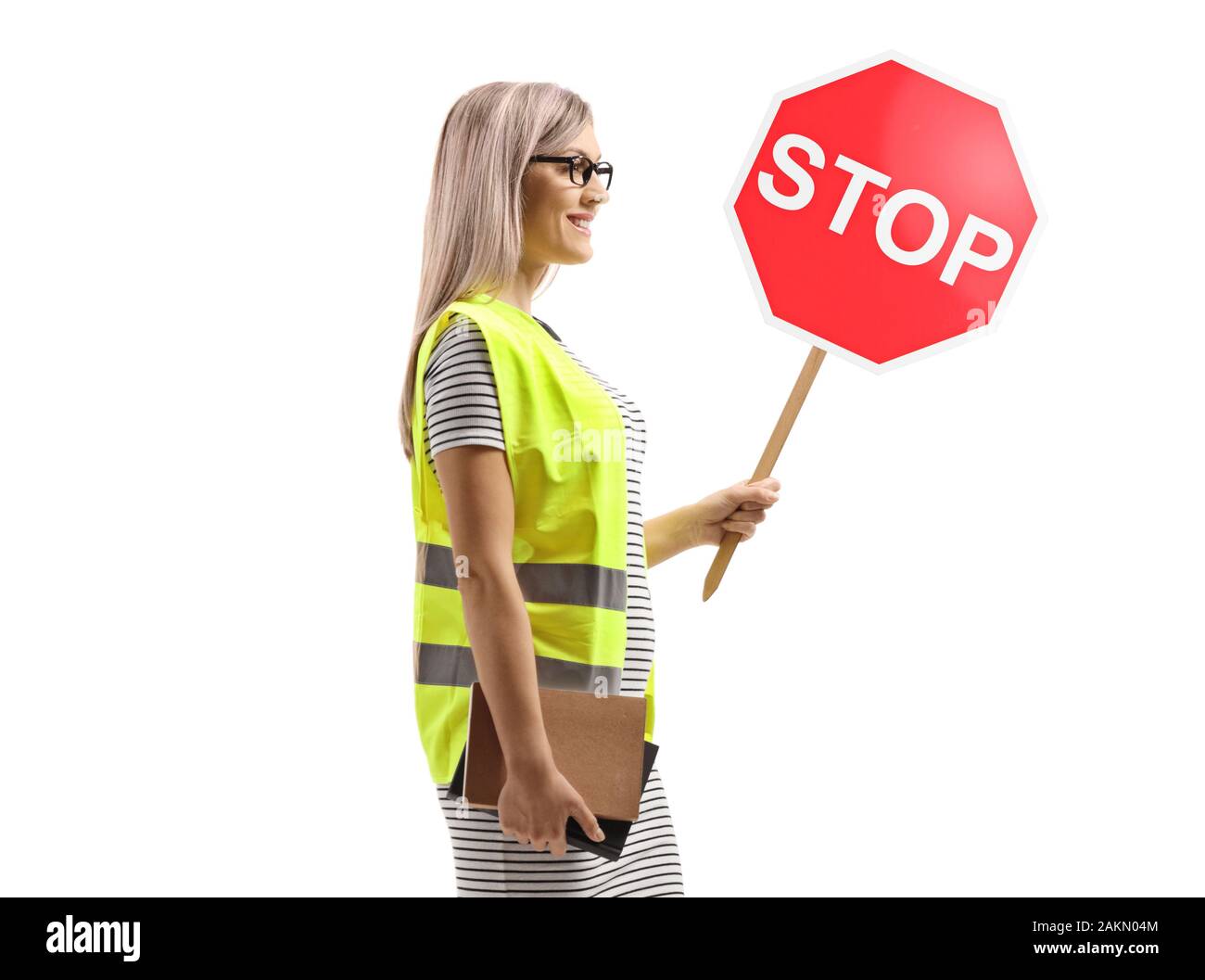 Woman holding a stop sign and books and wearing a safety vest isolated ...