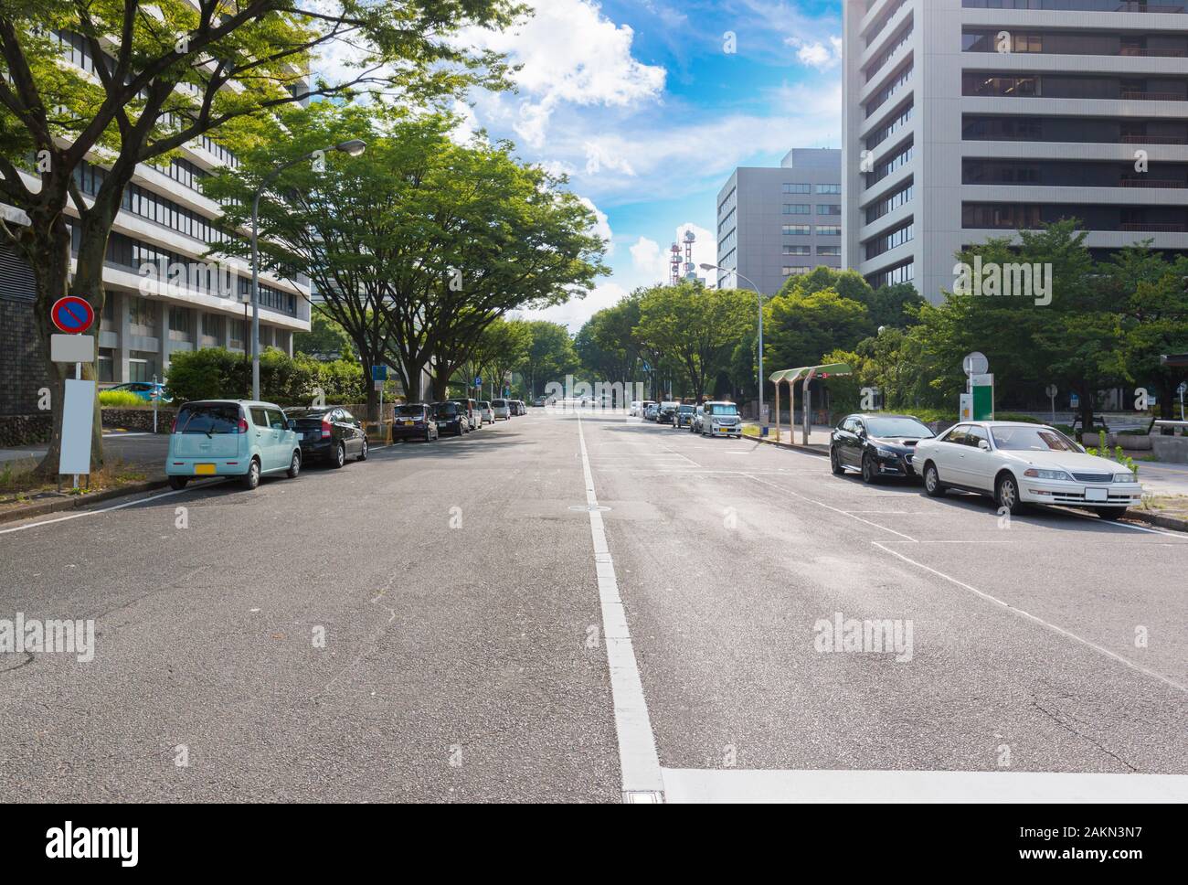 Empty urban road with cars parked beside the street Stock Photo - Alamy