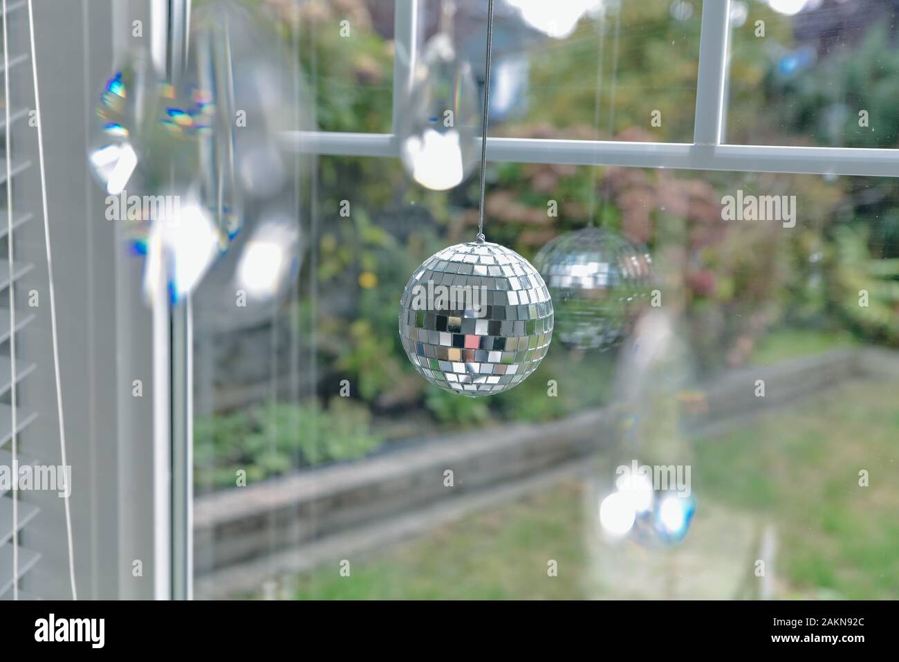 little disco ball sees by the window Stock Photo - Alamy