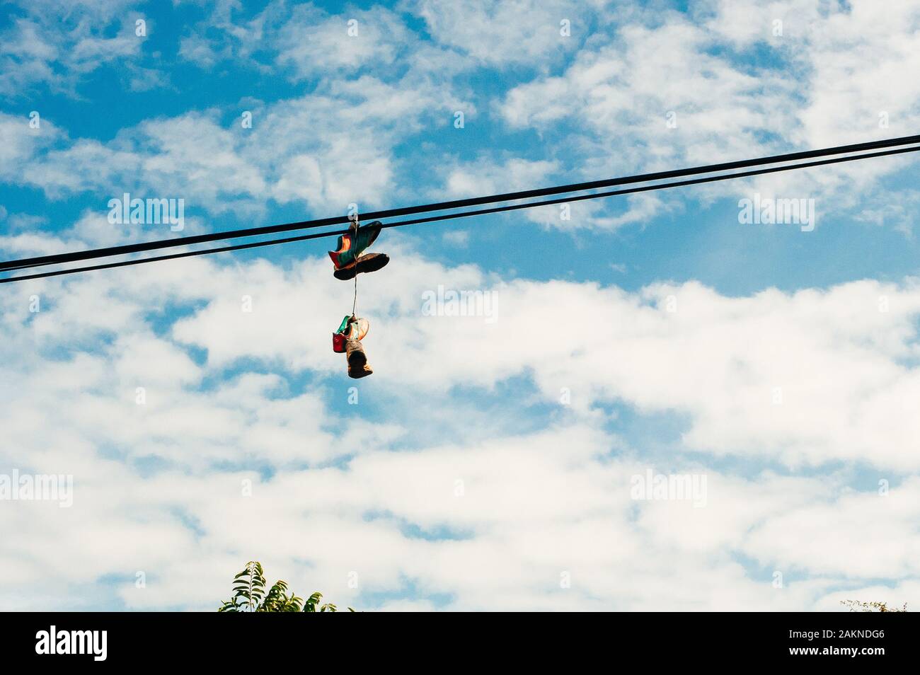 Sneakers hanging telephone wire hi-res stock photography and images - Alamy