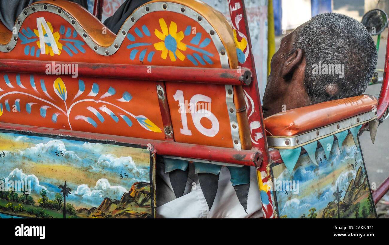 KOLKATA,WEST BENGAL/INDIA-MARCH 19 2018:A cycle rickshaw driver dozes ...