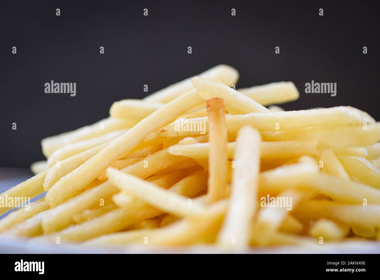 French fries on black background / Tasty potato fries for food or snack ...