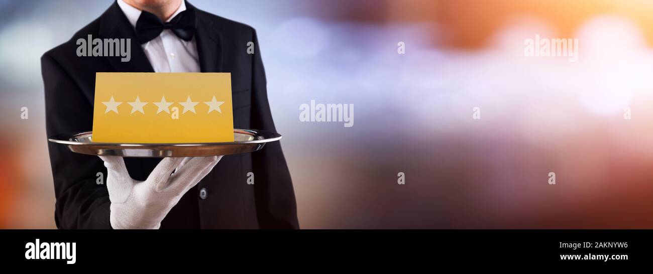 Portrait Of African Waiter Holding Plate With Star Rating Stock Photo ...
