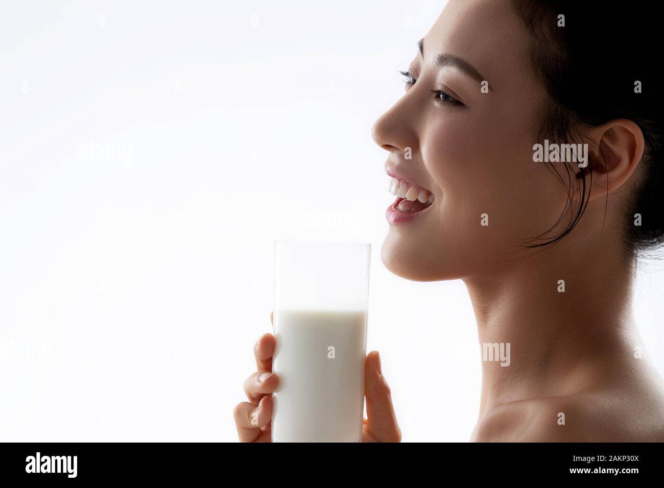 Young women drinking milk Stock Photo - Alamy