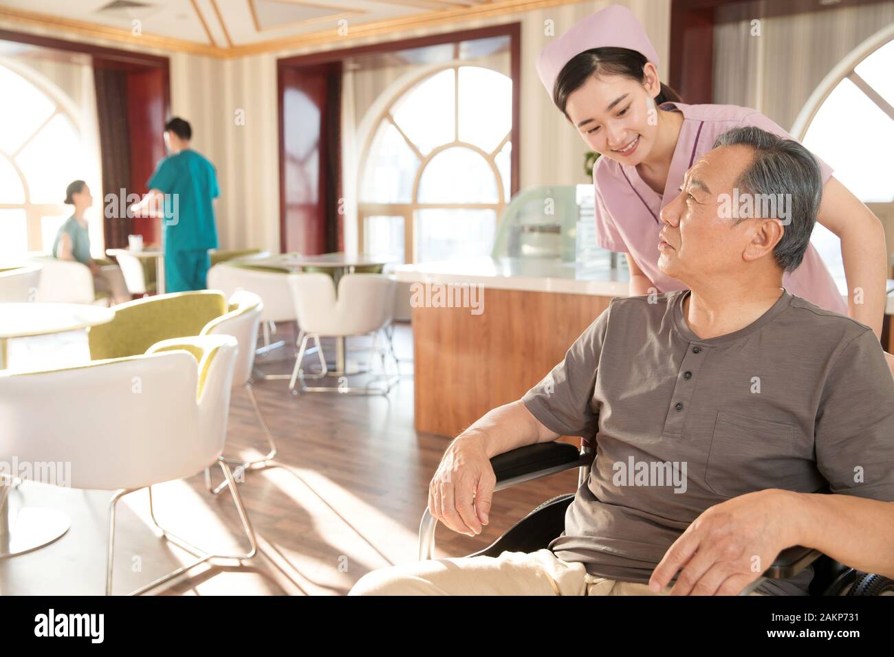 The nurse pushing a wheelchair elderly people Stock Photo - Alamy