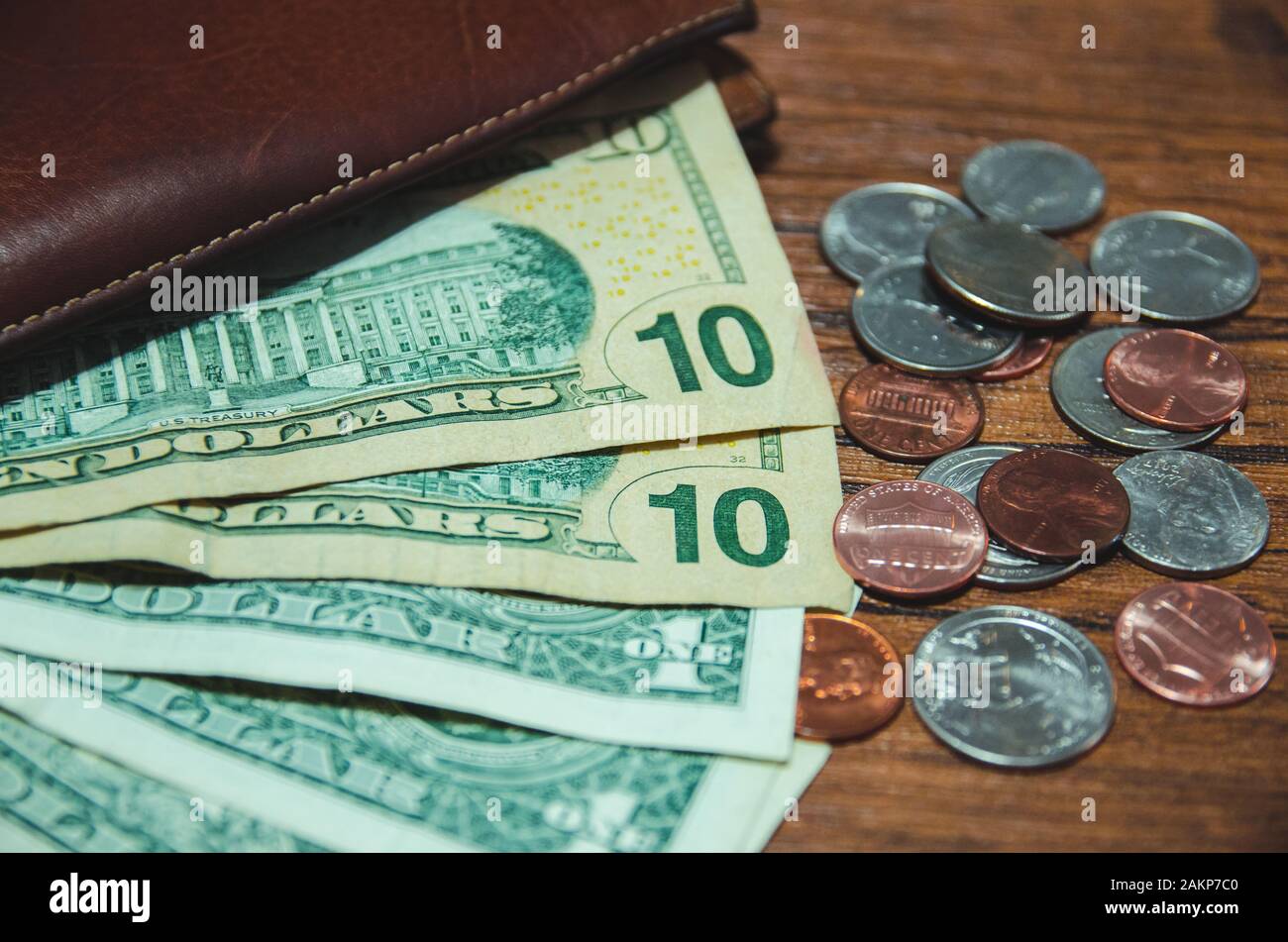 dollar bill with coin on pocket Stock Photo - Alamy
